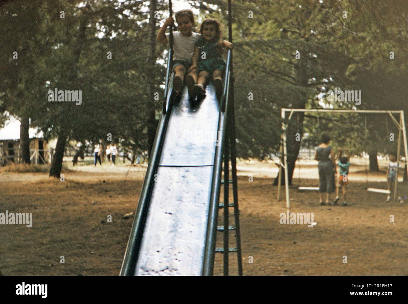 Children ready to go down a slide in a playground ca. 1955-1959 Stock ...