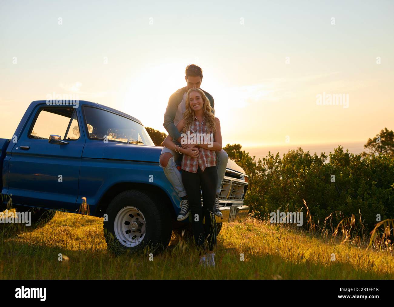 Couple, portrait and sunset by pickup truck in nature for road trip ...