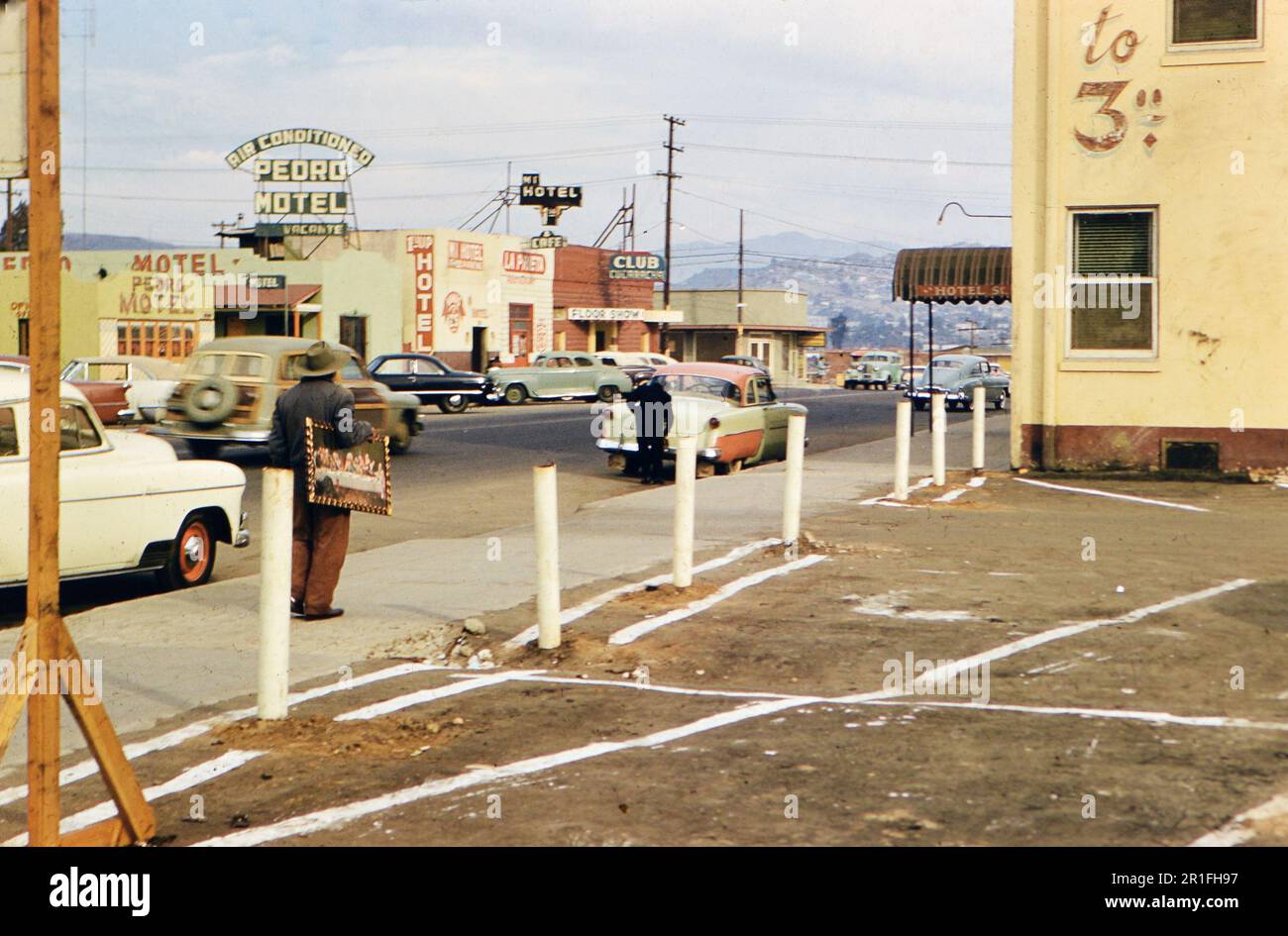 Scene in downtown Tijuana Mexico, man with Last Supper picture under ...