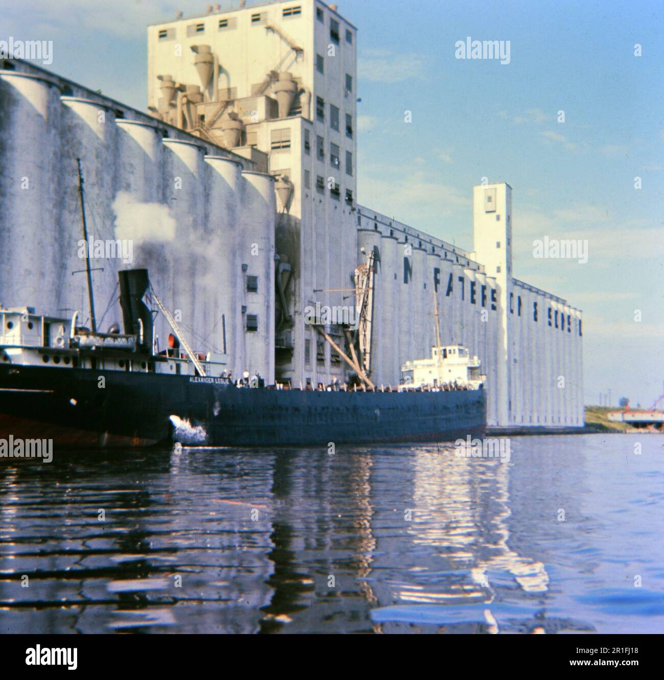 The ship Alexander Leslie pulled alongside a huge grain elevator ...