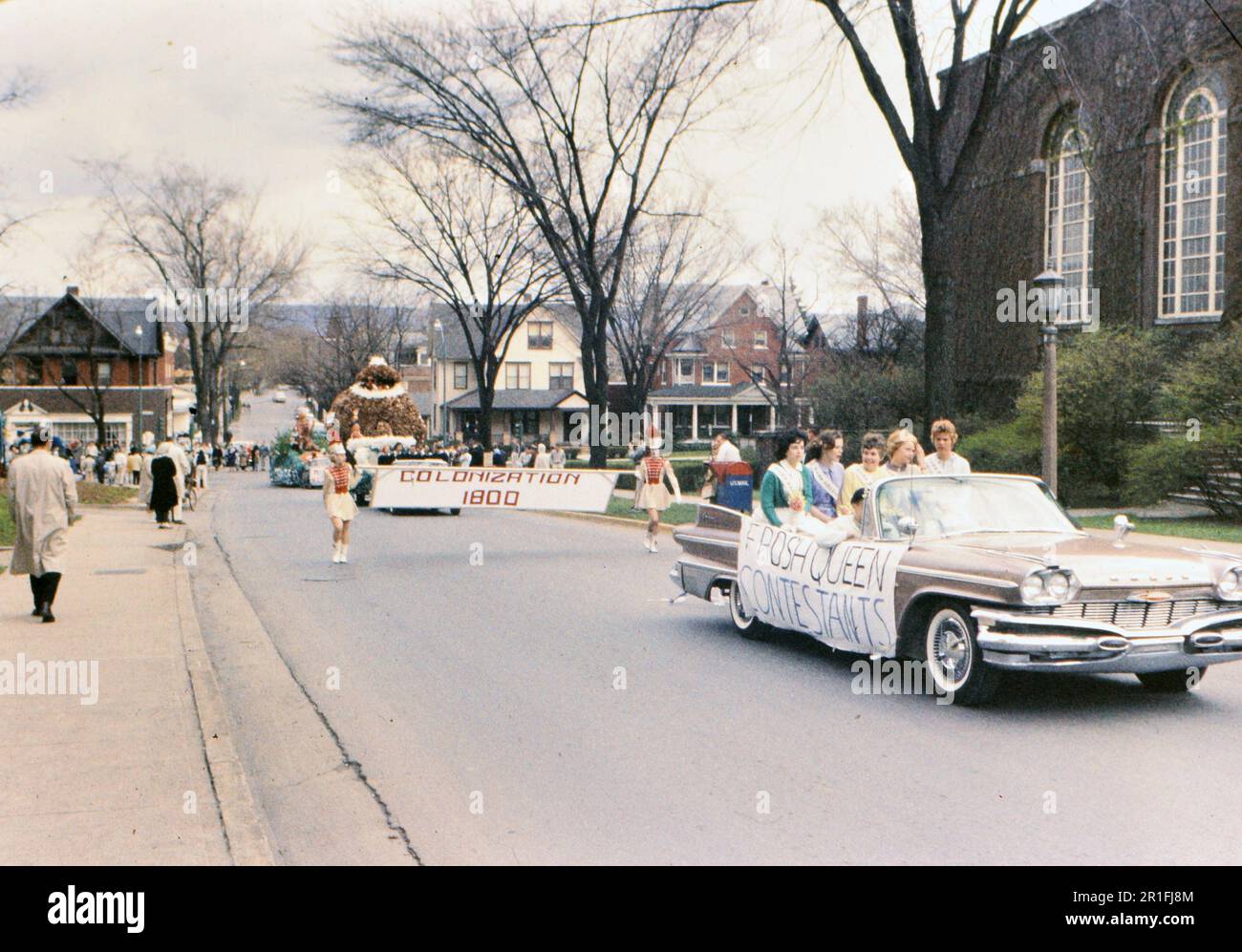 Car carrying freshman queen contestants ride in a parade ca. 1955-1965 ...