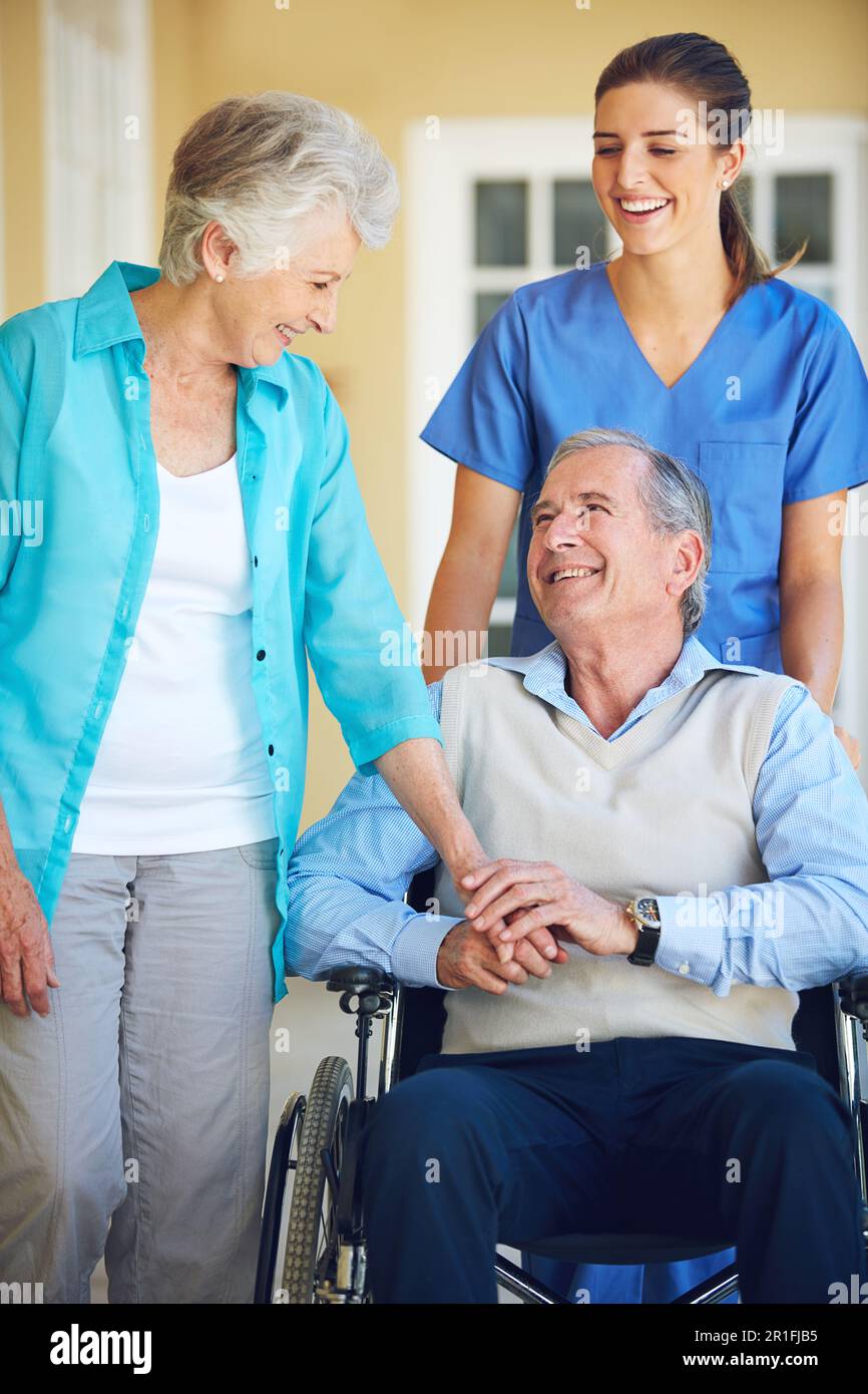 Wife, nurse laughing or old man in wheelchair in hospital clinic ...