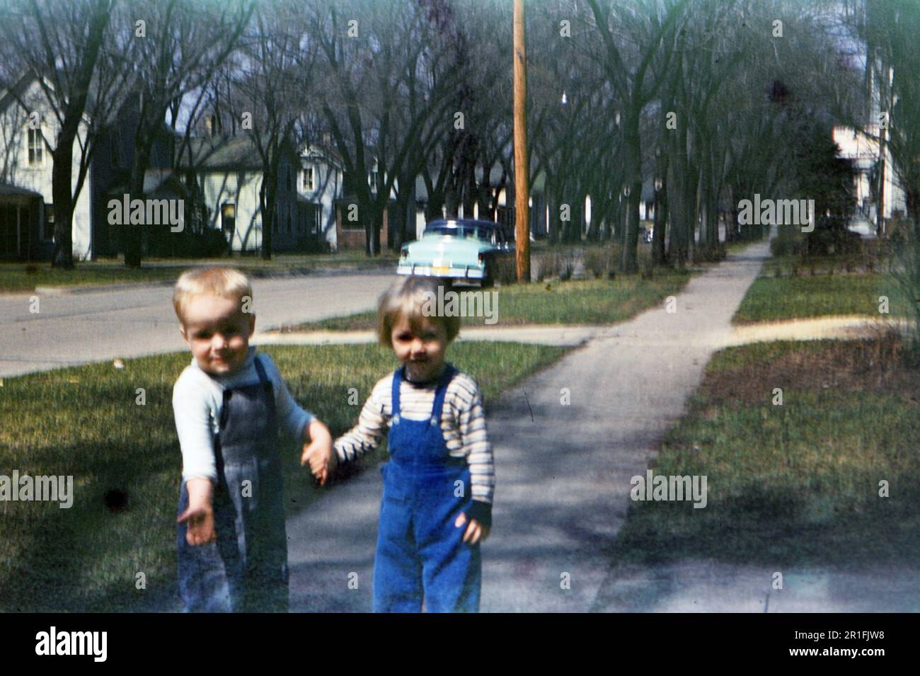 Two toddlers holding hands outdoors ca. 1955-1959 Stock Photo - Alamy