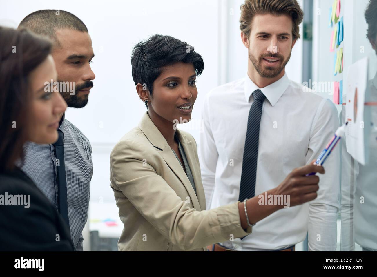 Woman, manager talk and business group at whiteboard talking about a ...