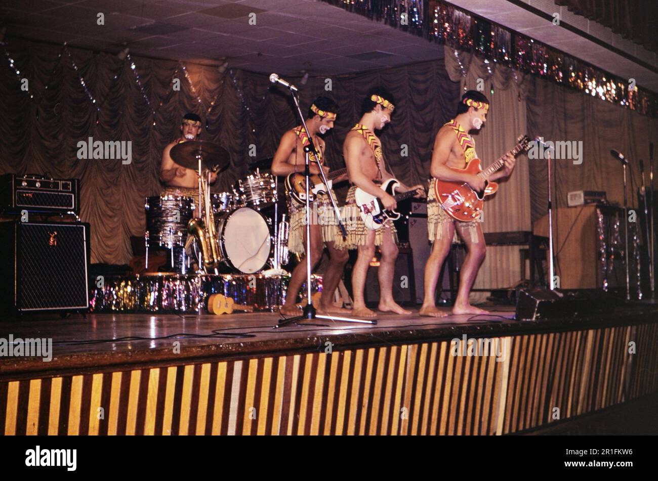 Band performing, dressed in Hawaiian themed costumes ca. 1965-1972 ...