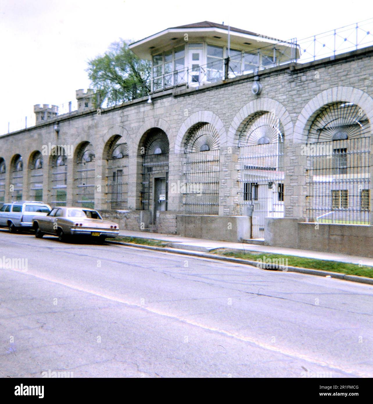 Cars parked outside of a prison (possibly a maximum security prison) ca ...