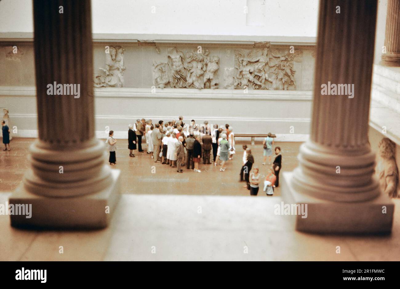 Group of tourists on a tour inside a museum, likely the Pergamon Museum ...