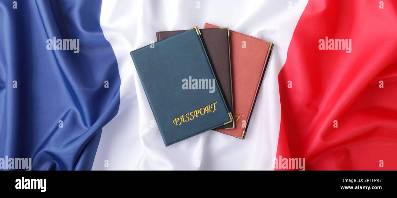 Passports on flag of France. Immigration concept Stock Photo - Alamy