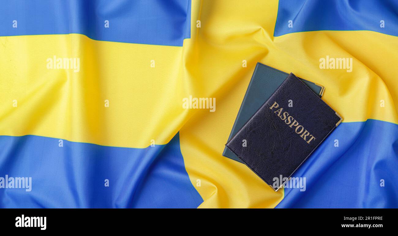 Passports on flag of Sweden. Immigration concept Stock Photo - Alamy