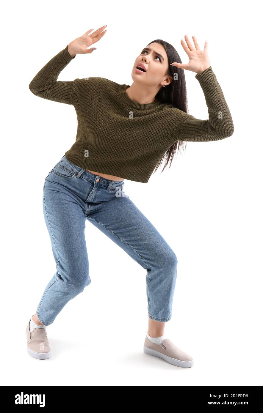 Scared young woman on white background Stock Photo - Alamy