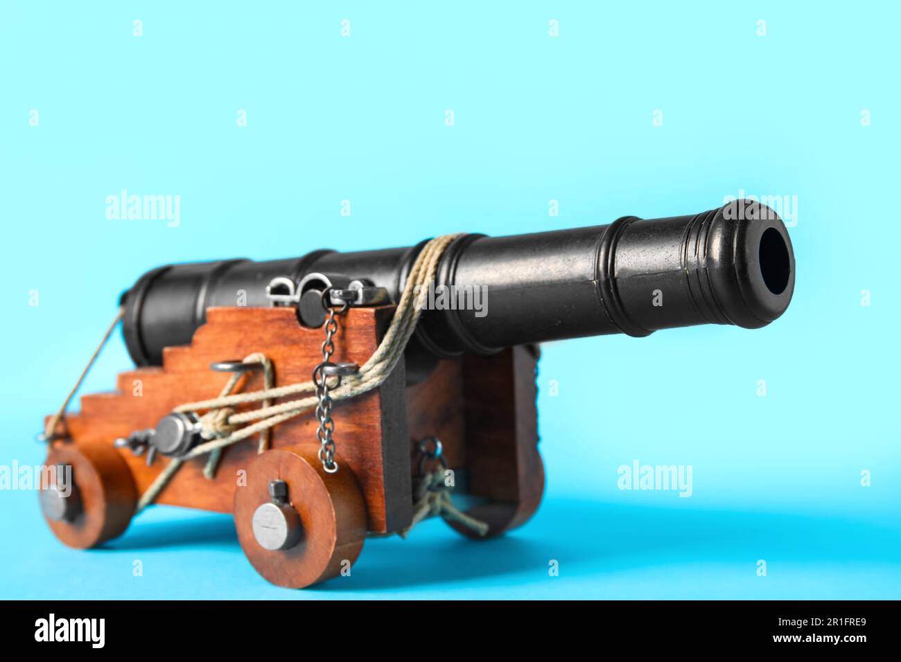 Toy model of cannon on blue background Stock Photo - Alamy