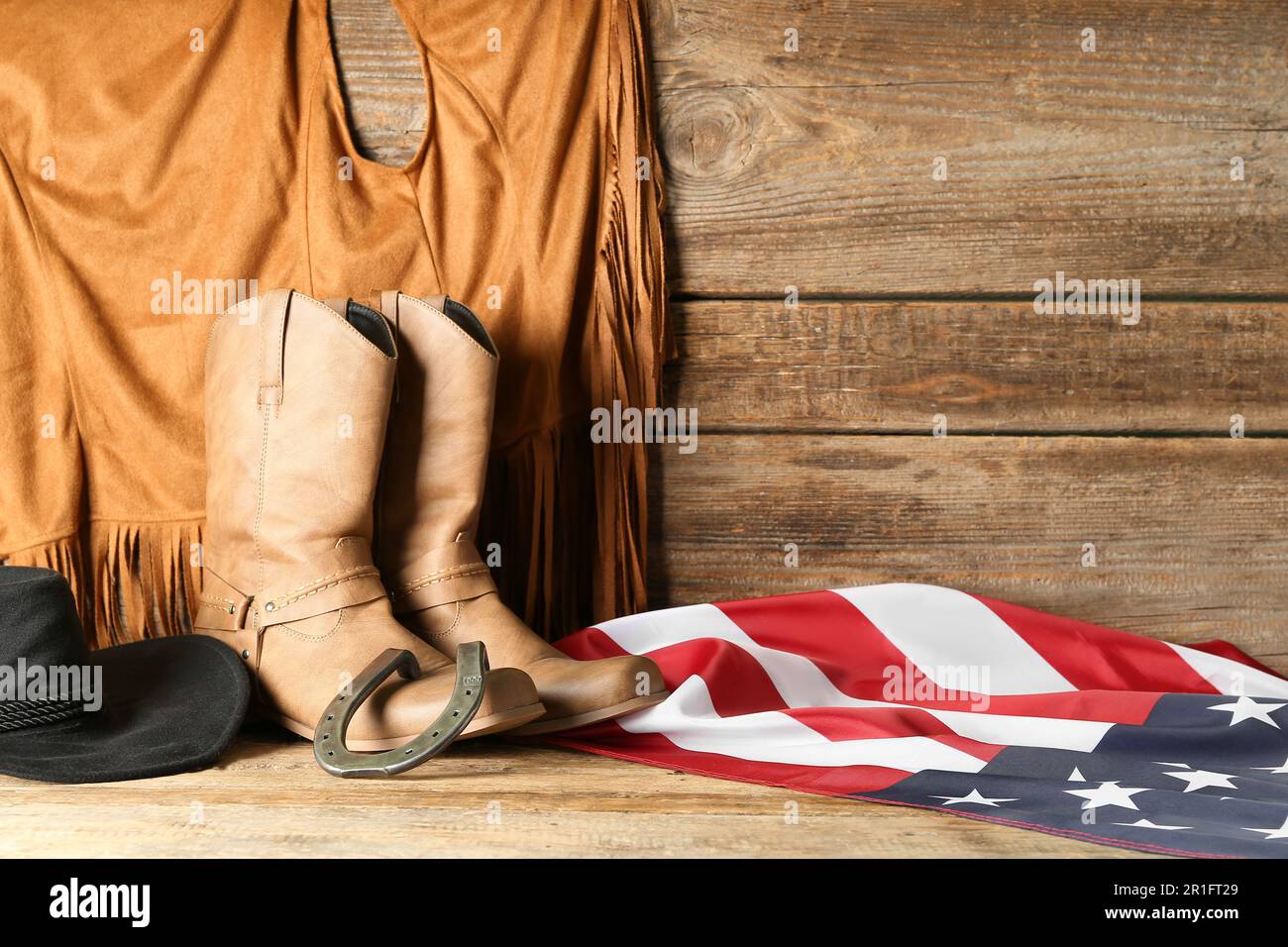 Cowboy hat, boots and flag of USA on wooden background Stock Photo - Alamy