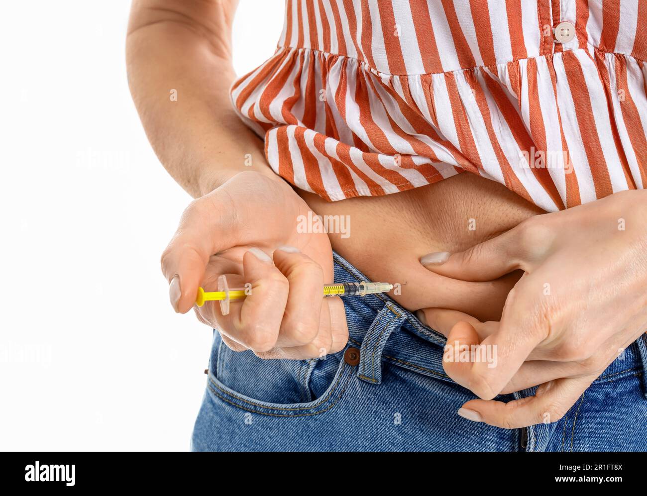 Mature diabetic woman giving herself insulin injection on white ...