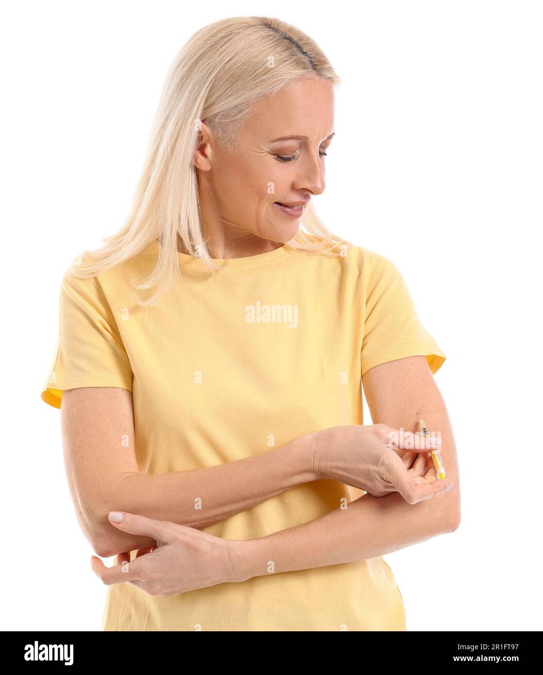 Mature diabetic woman giving herself insulin injection on white ...
