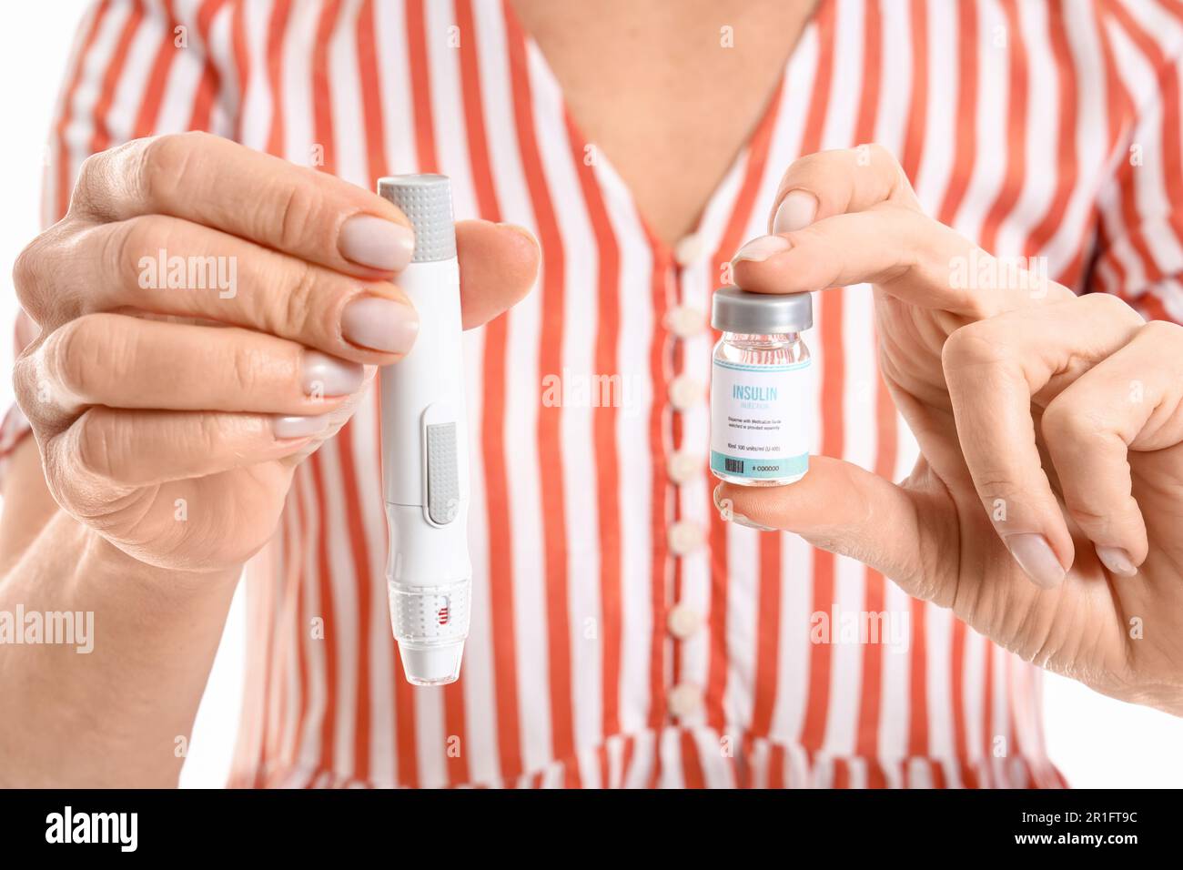 Mature diabetic woman with lancet pen and insulin on white background ...