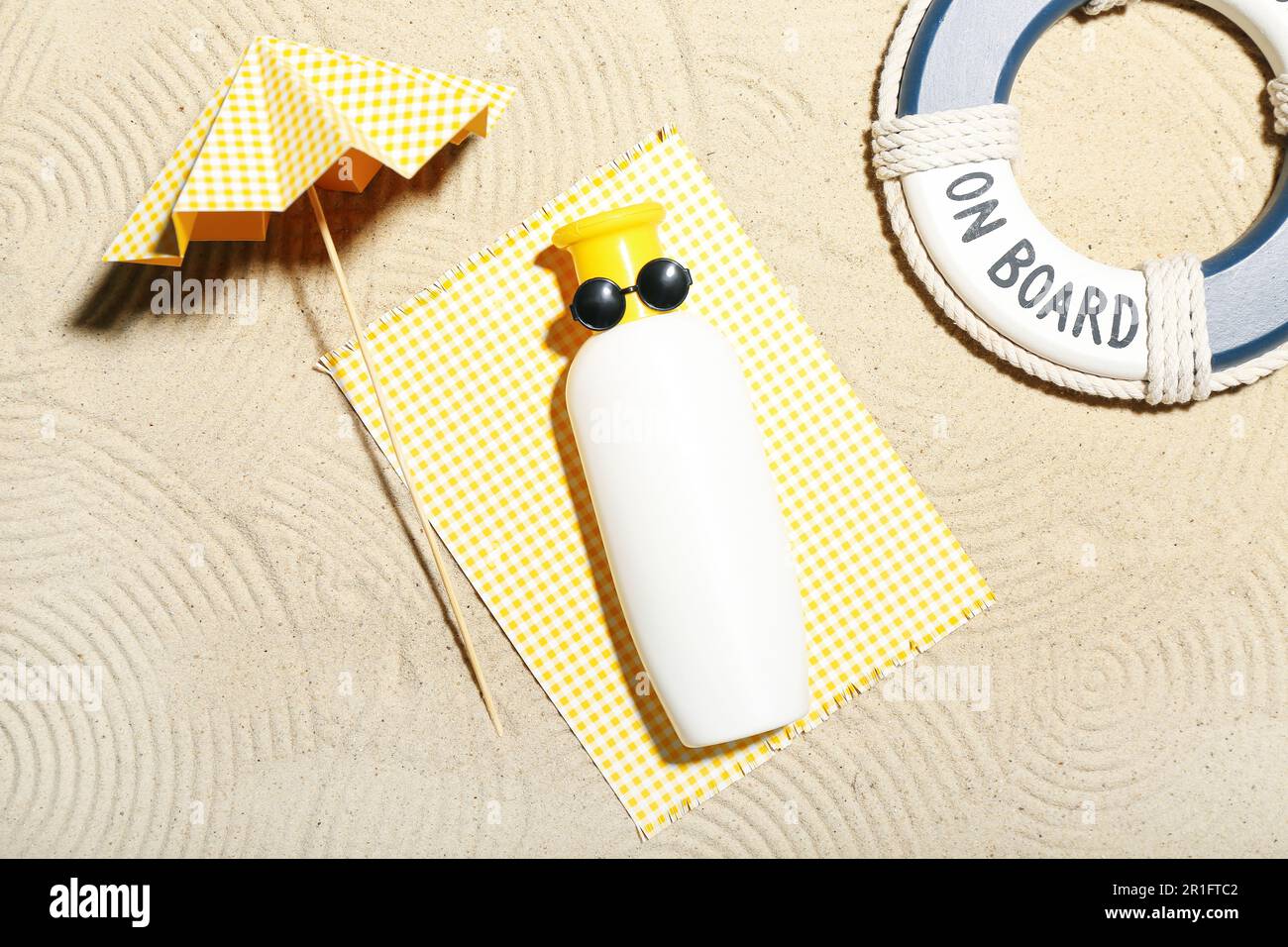 Creative composition with sunscreen, miniature umbrella and lifeline on ...