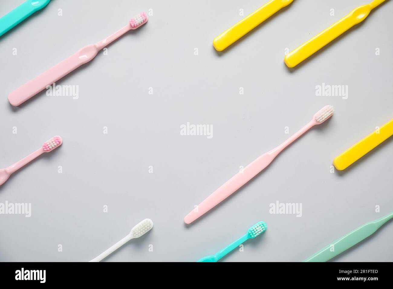 Plastic toothbrushes on grey background Stock Photo - Alamy