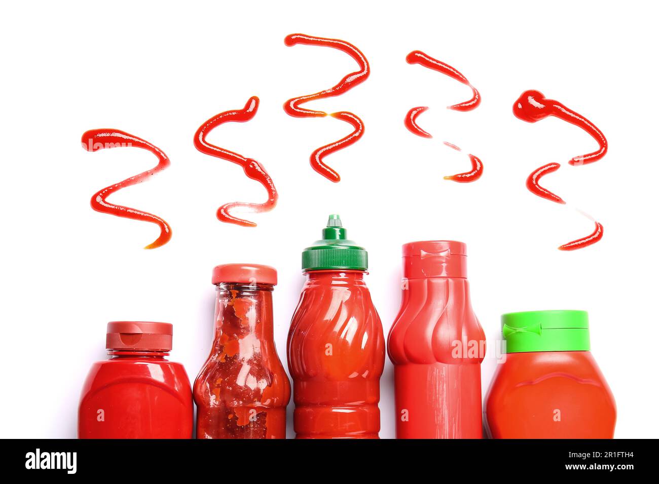 Ketchup squeezed out of bottles on white background Stock Photo - Alamy