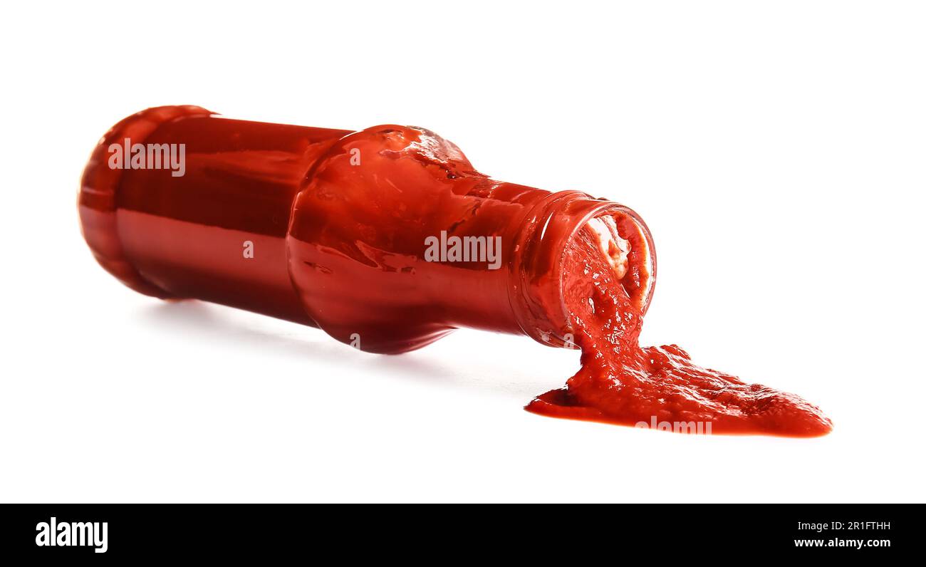Ketchup spilled out of glass bottle on white background Stock Photo - Alamy