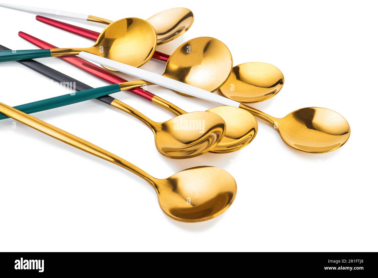 Golden spoons with colorful handles on white background Stock Photo - Alamy