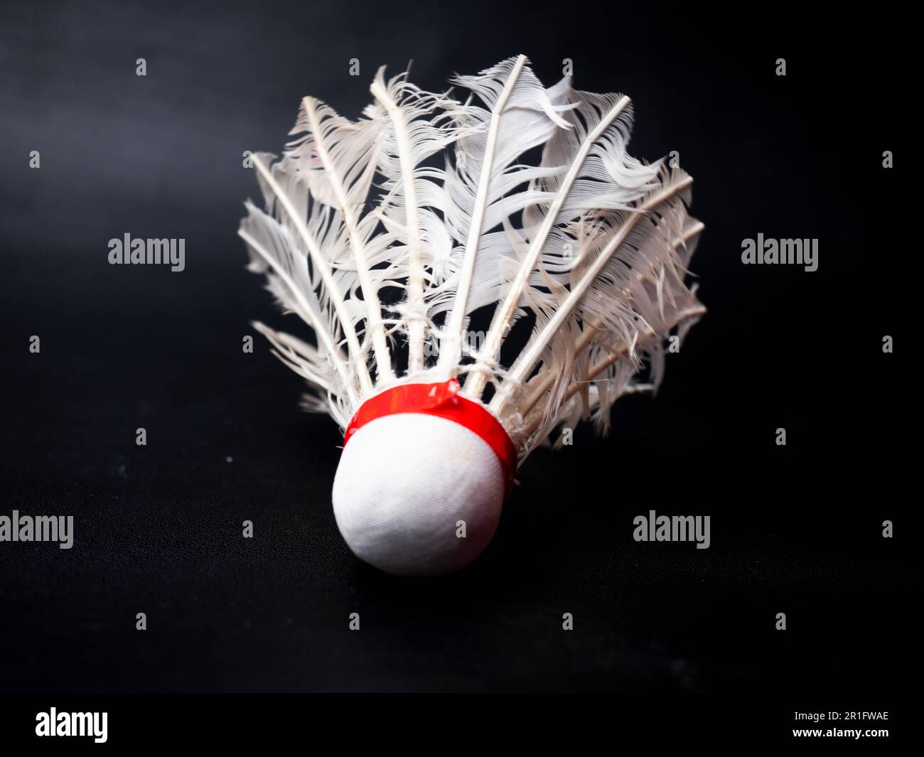 Picture of a broken shuttlecock on a black isolated background Stock ...