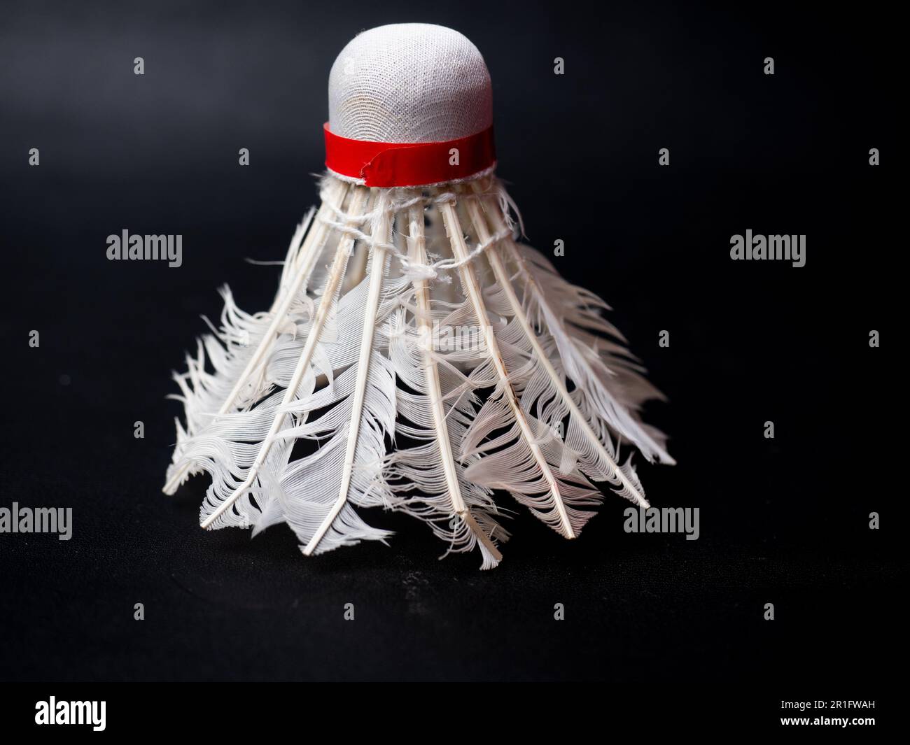 Picture of a broken shuttlecock on a black isolated background Stock ...