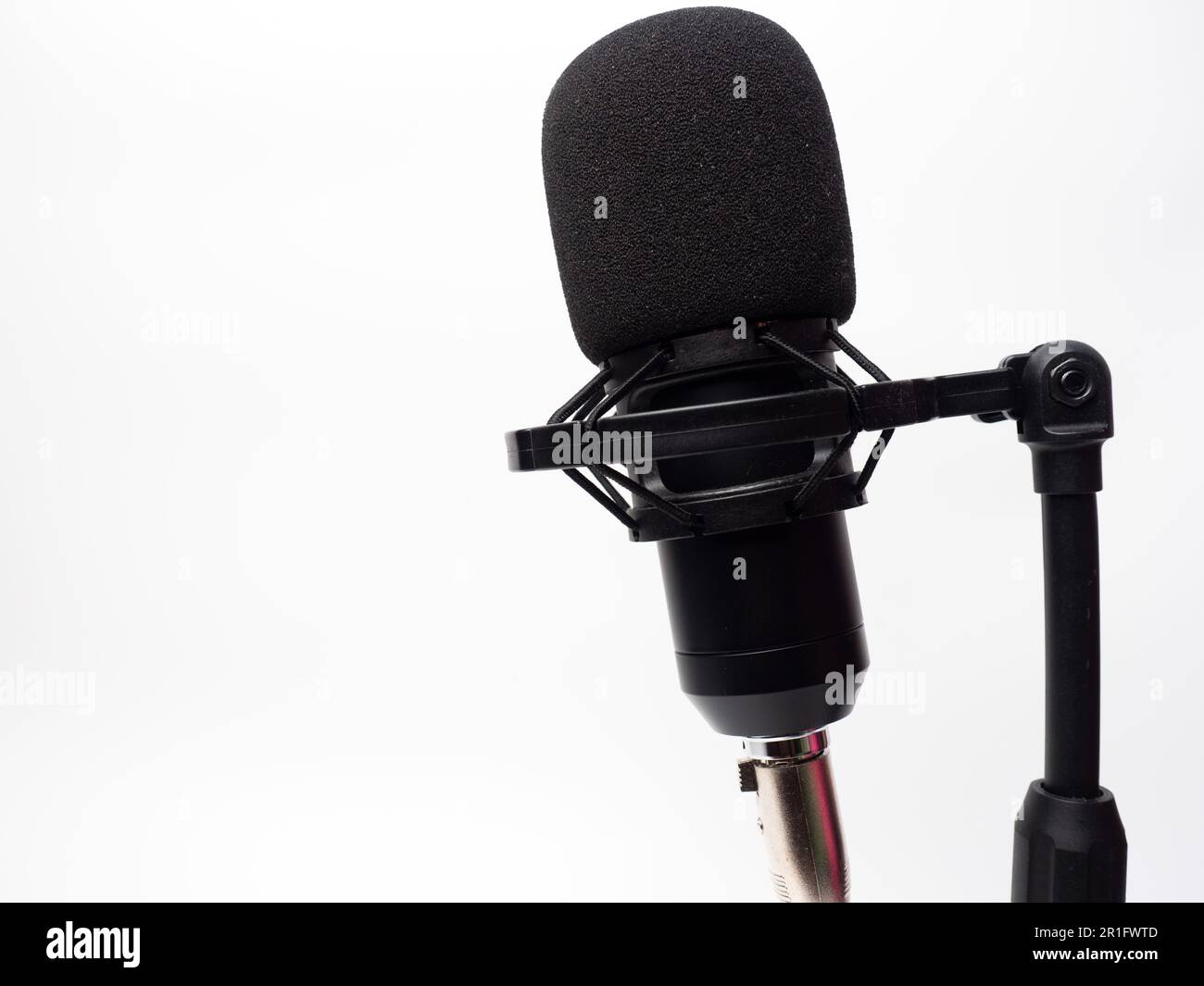 Picture of a black condenser microphone on a white isolated background ...