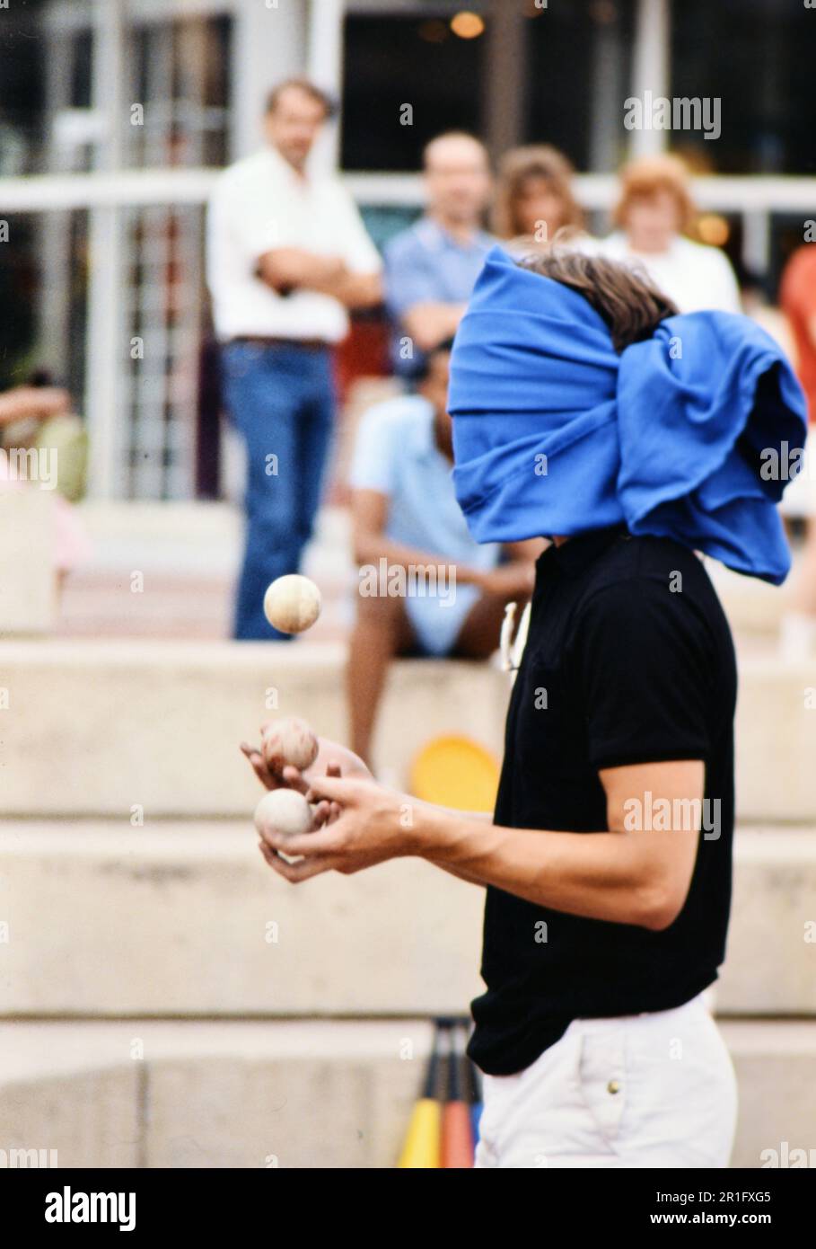 A performer juggling in front of a crowd at Harborplace in Baltimore ca ...