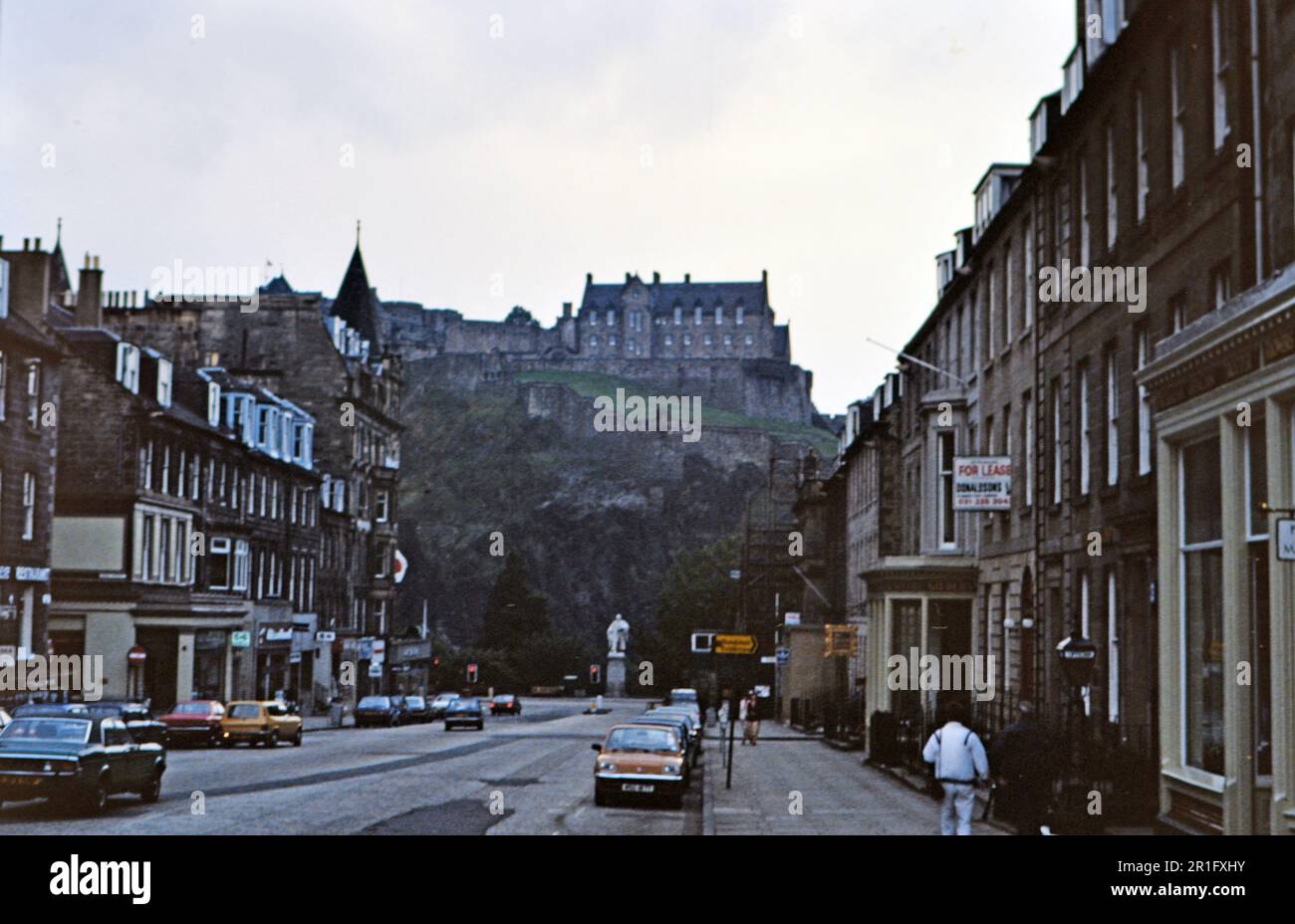 Street scene in Edinburgh Scotland; Edinburgh Castle on top of the hill ...