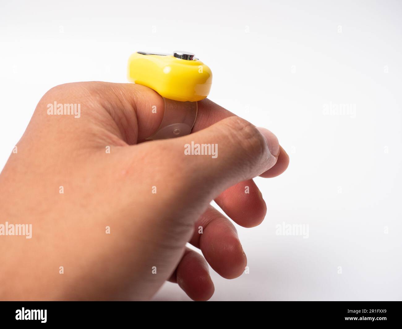 Picture of a yellow digital tally counter on a white background Stock ...