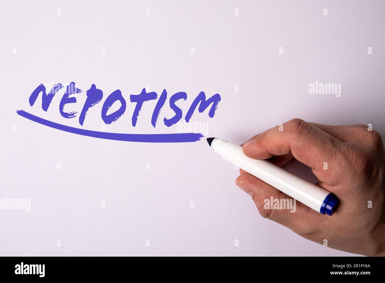 Nepotism. Handwriting text with marker on a white background Stock ...