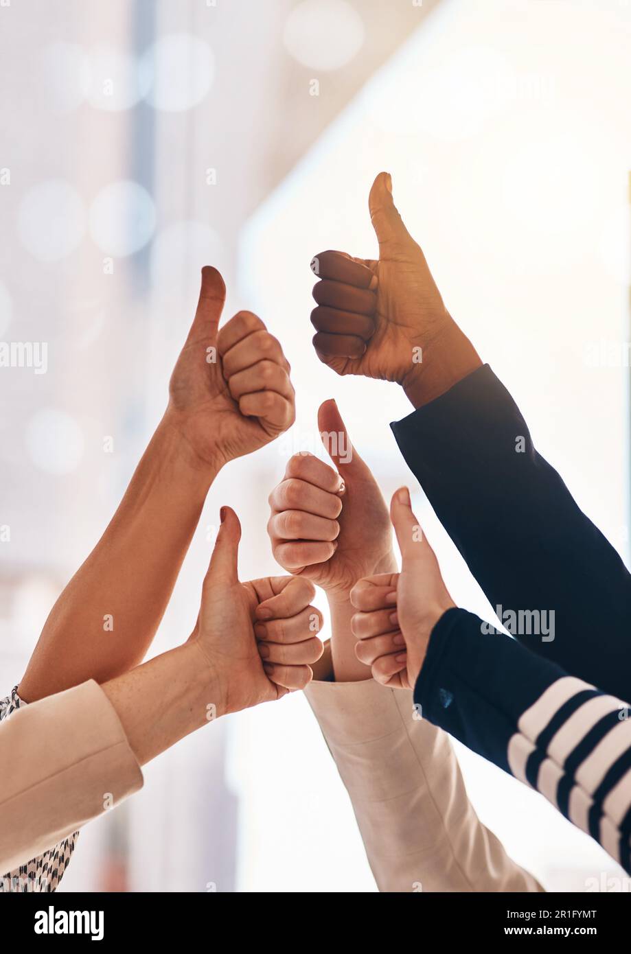 Hands, collaboration and thumbs up with a business team in the office ...