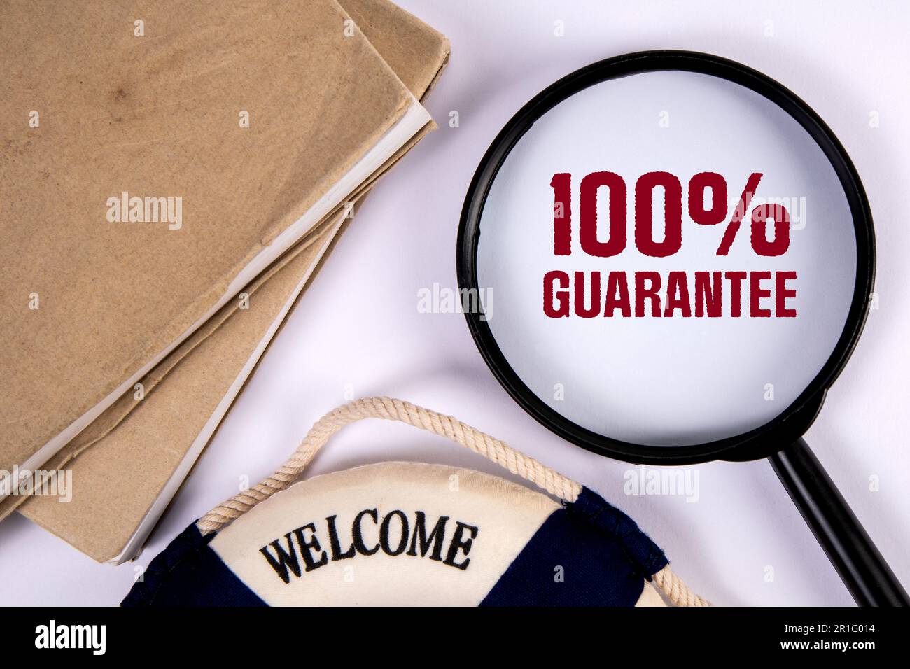 Guarantee Concept. Magnifying glass and books on a white backgroun ...