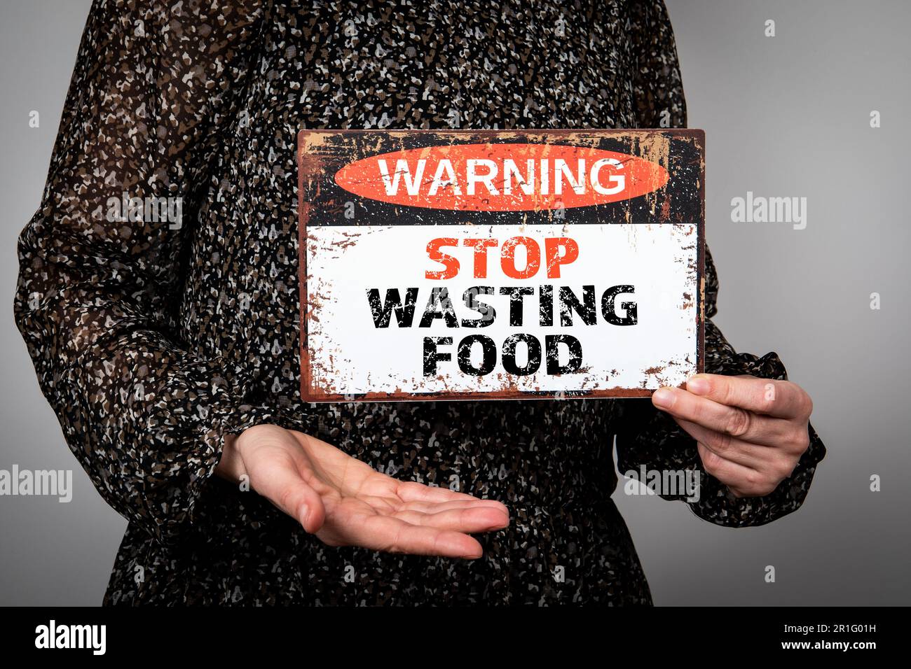 Stop Wasting Food. Warning sign with text in the hands of a woman Stock ...