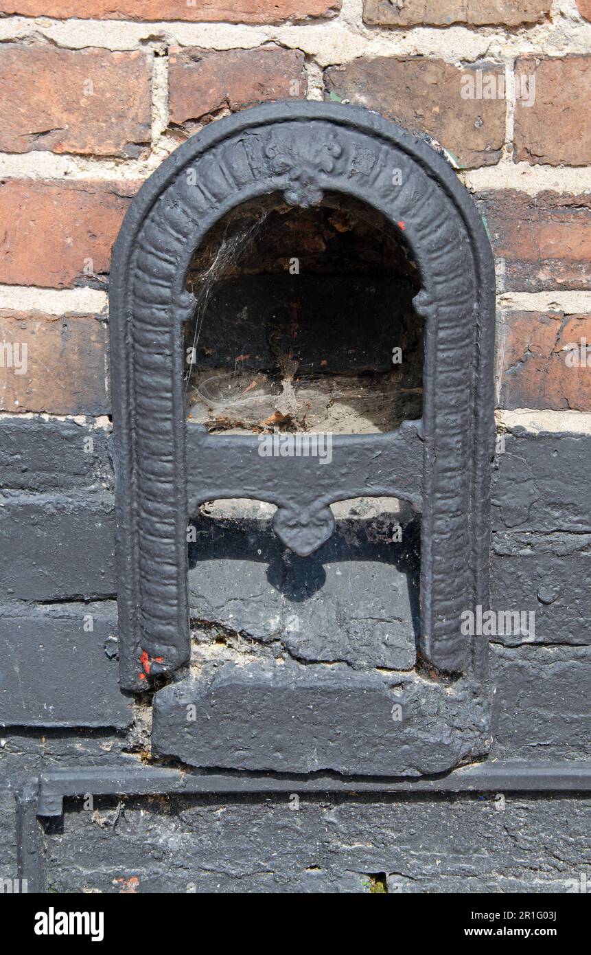 Old Victorian boot mud scraper in wall painted black with brickwork ...