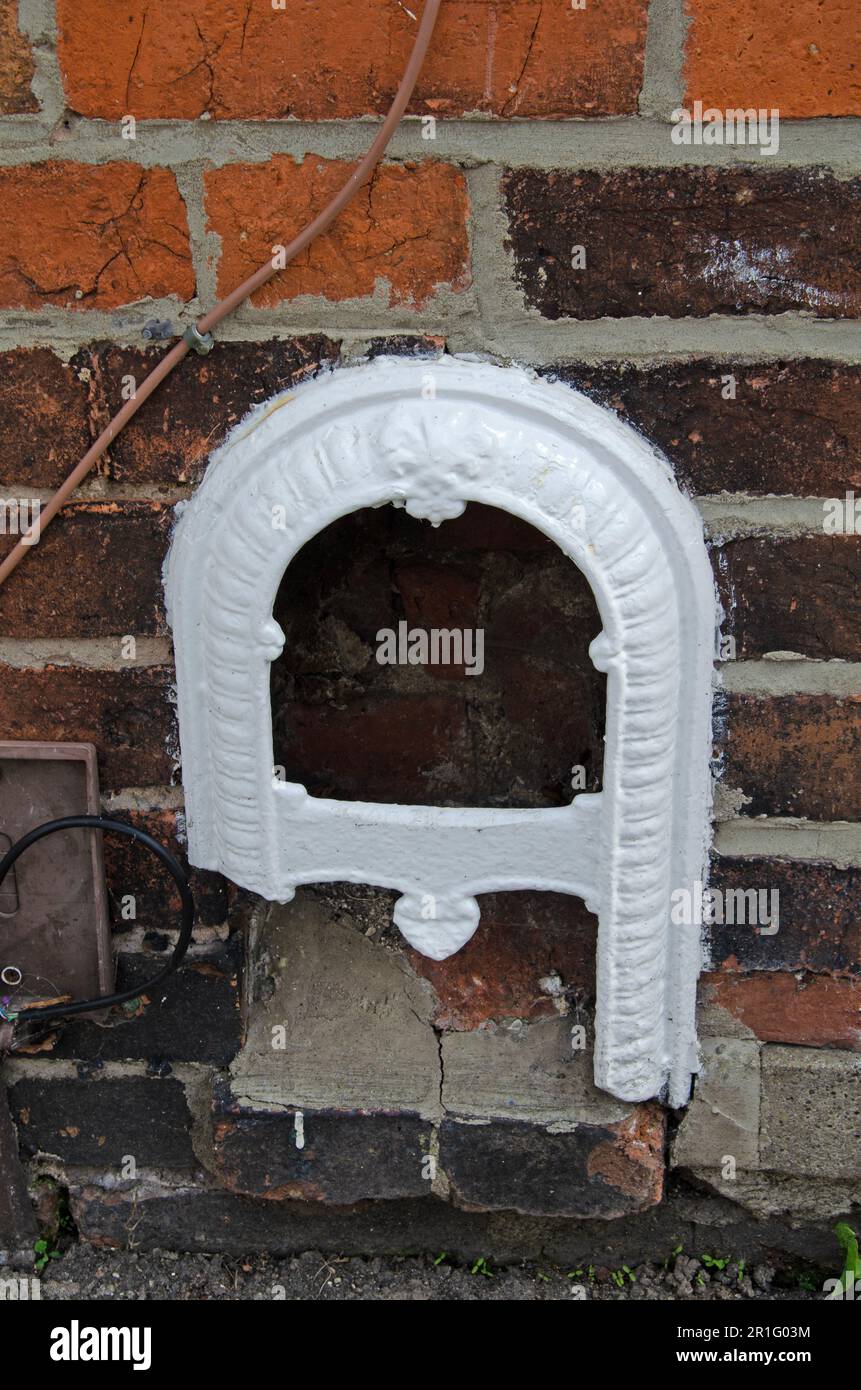 Old boot mud scraper in wall painted white with brickwork Stock Photo ...