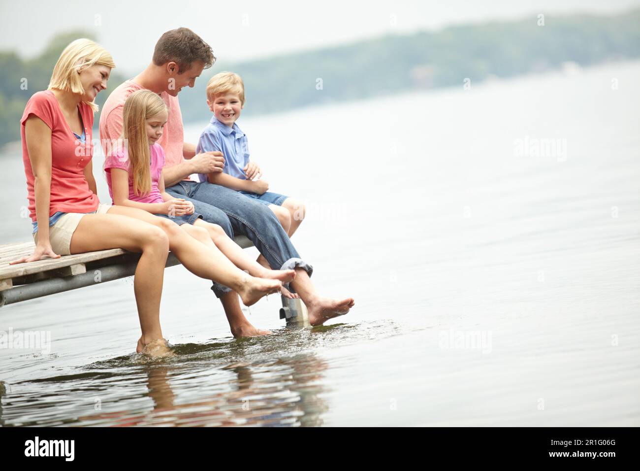 Holiday, lake and family with kids with foot in water during summer ...