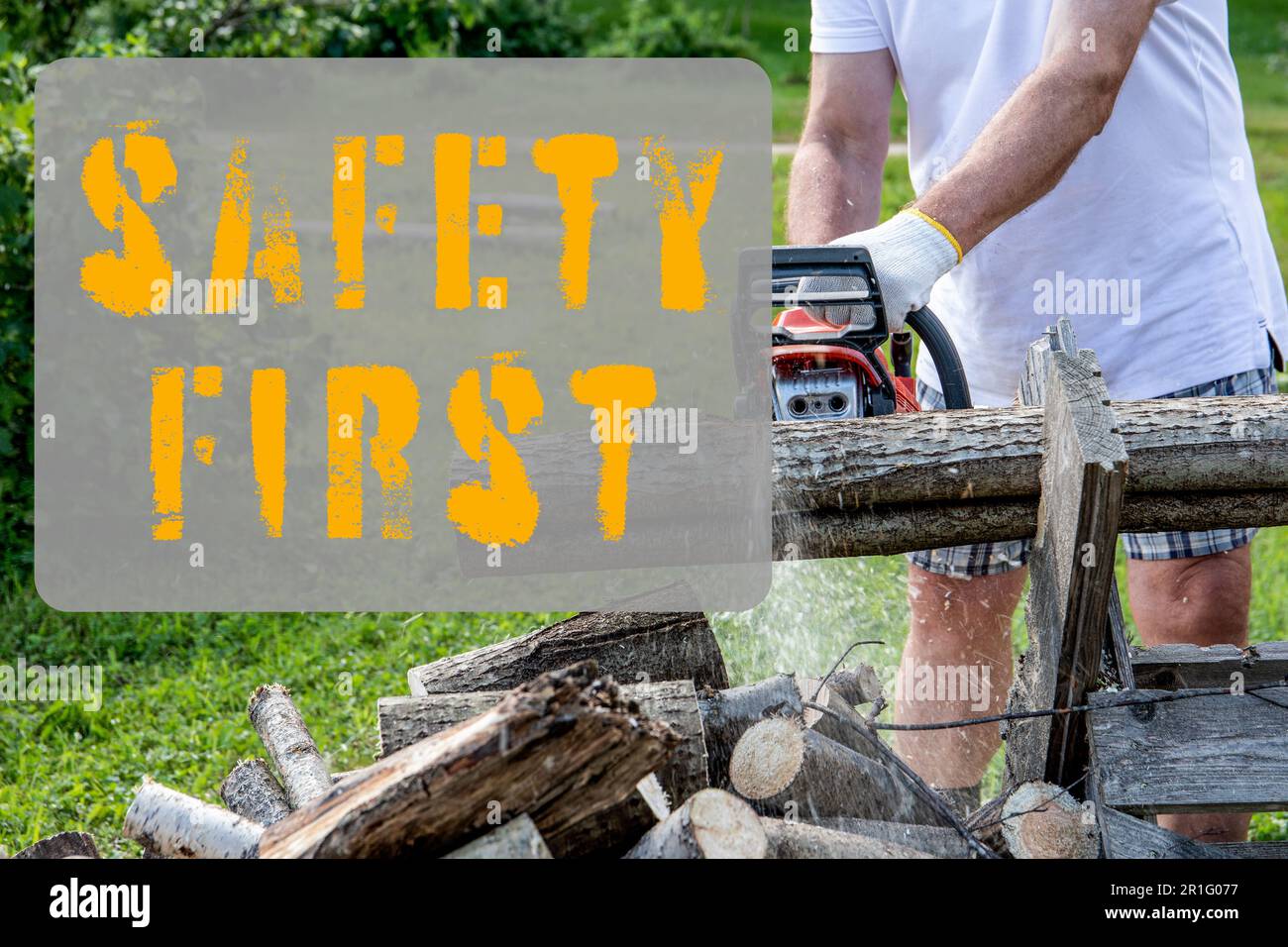 Safety First Concept. Man cuts wood with a chainsaw Stock Photo - Alamy