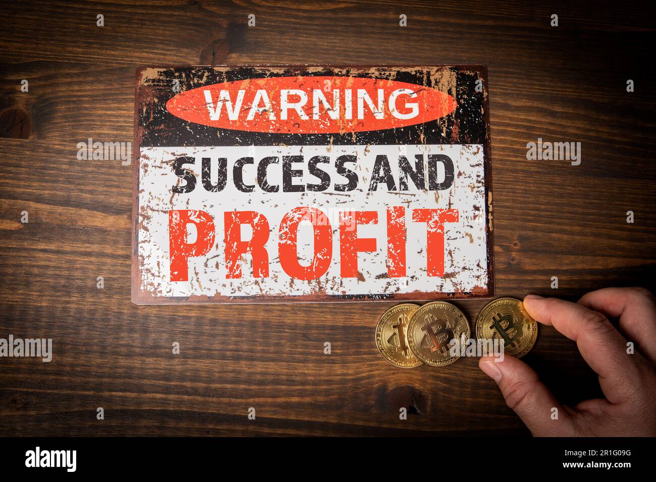Success and Profit. Warning sign and bitcoin coins on wood texture ...