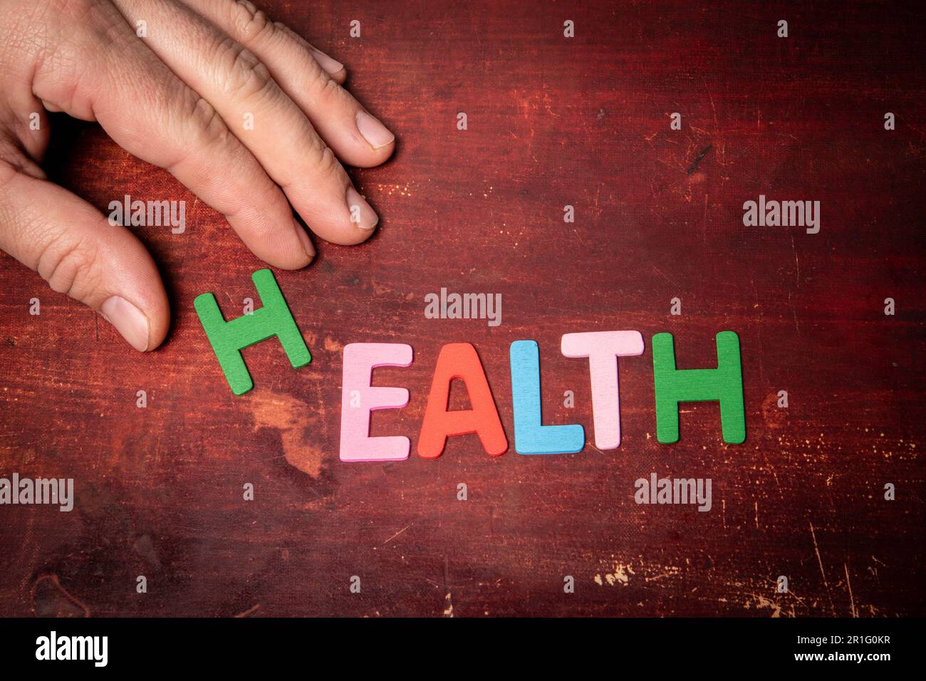 HEALTH. Text from colorful alphabet letters on a painted wooden ...