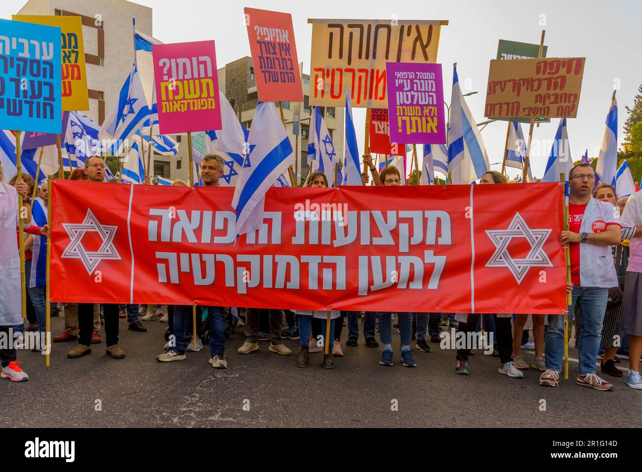 Haifa, Israel - May 13, 2023: People marching with flags and various ...