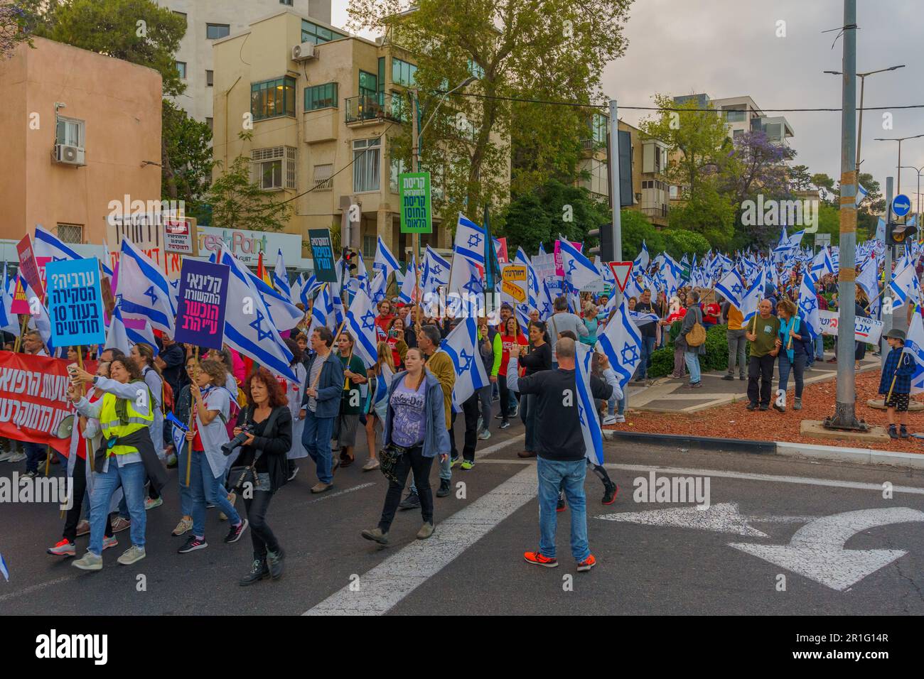 Haifa, Israel - May 13, 2023: People marching with flags and various ...