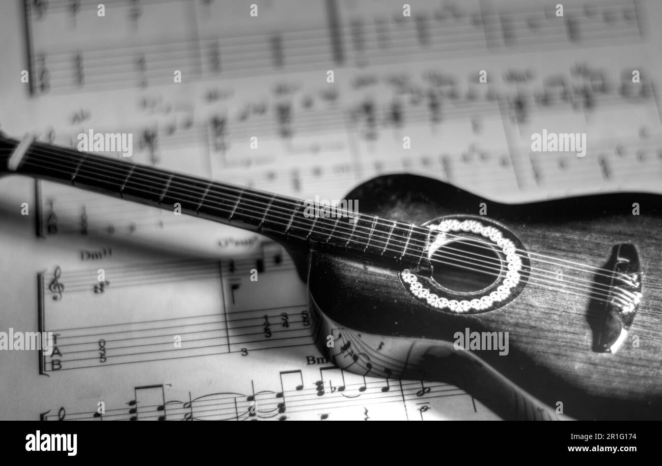a classical guitar over the notes of jazz music Stock Photo - Alamy