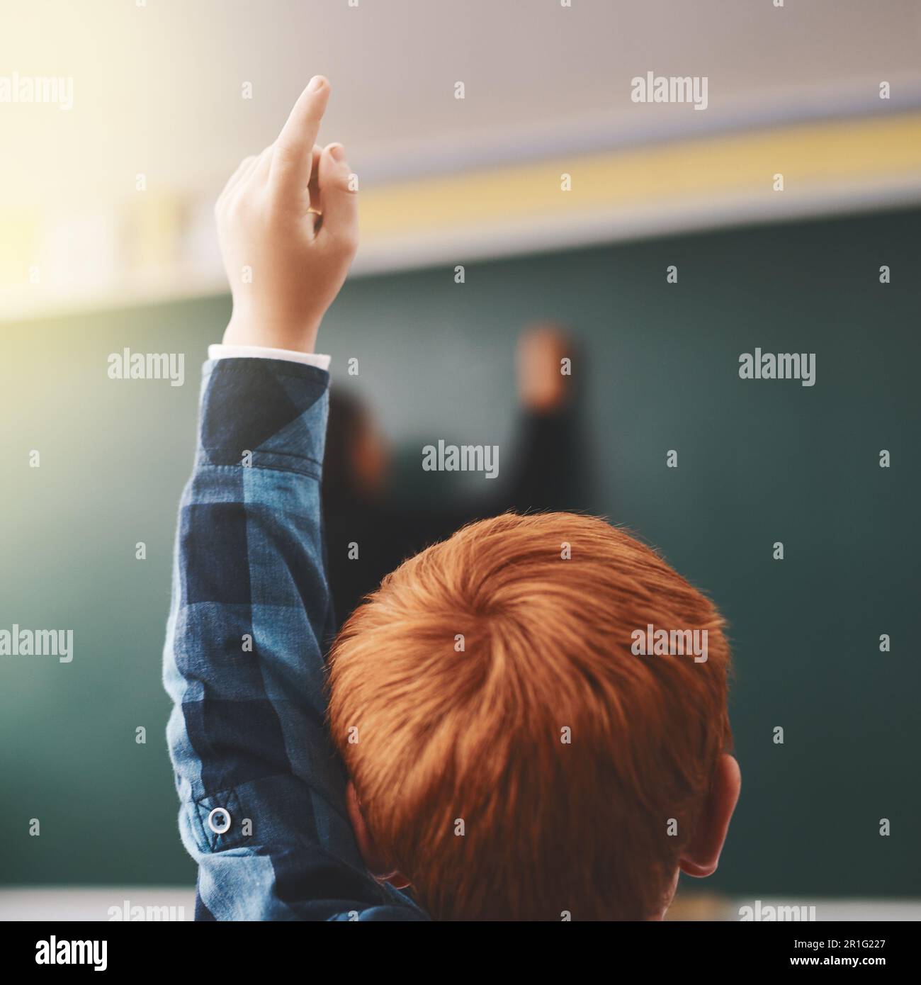 I have a question. elementary school children raising their hands to ...