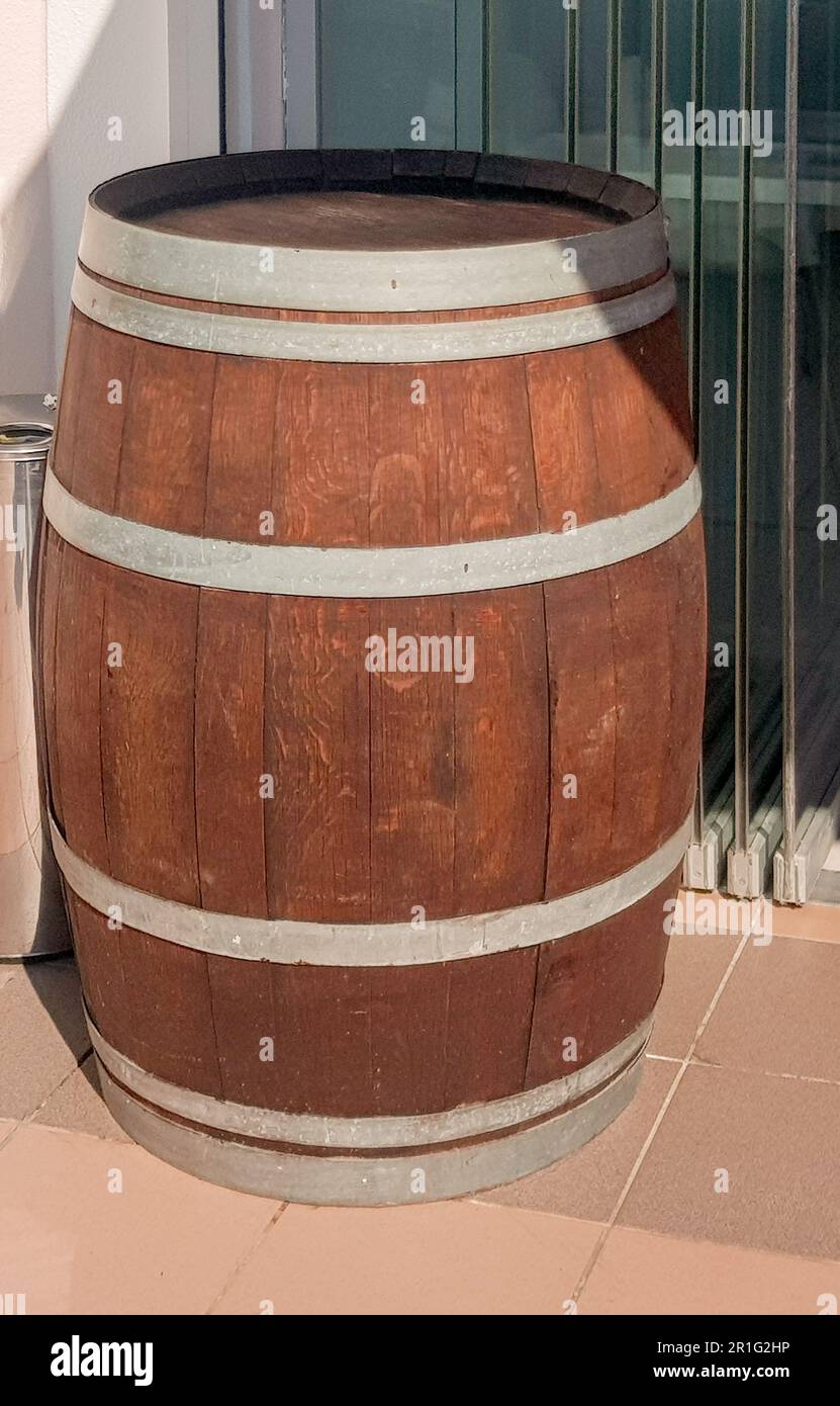 An old oak barrel stands at the entrance to a beer restaurant, shop, as ...