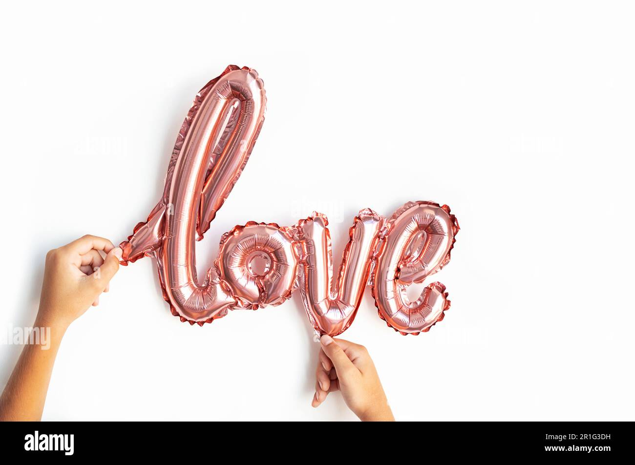 Human hands hold word Love from foil pink balloons Stock Photo - Alamy