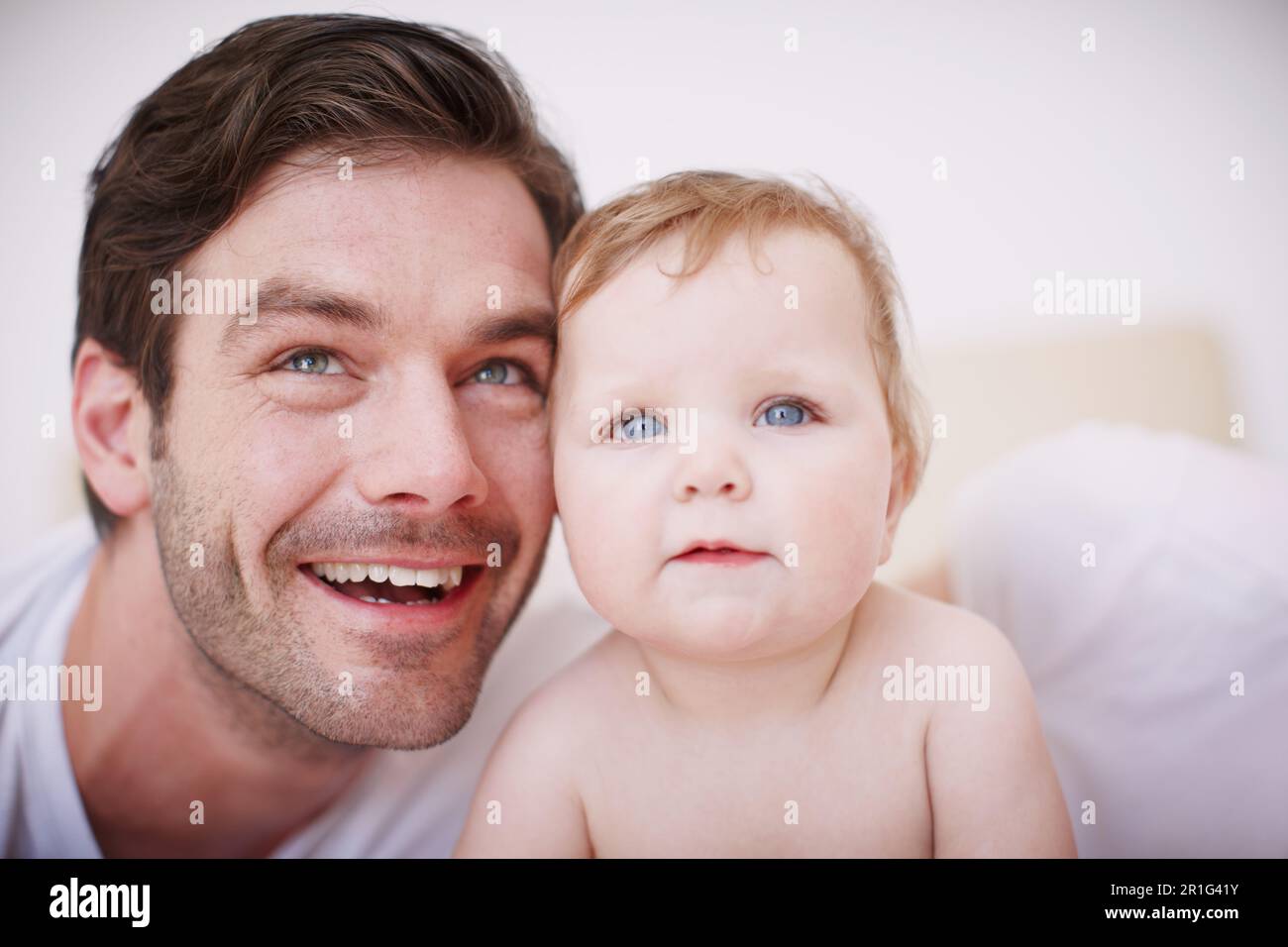 Sharing a curious nature. Two loving young parents and their adorable ...