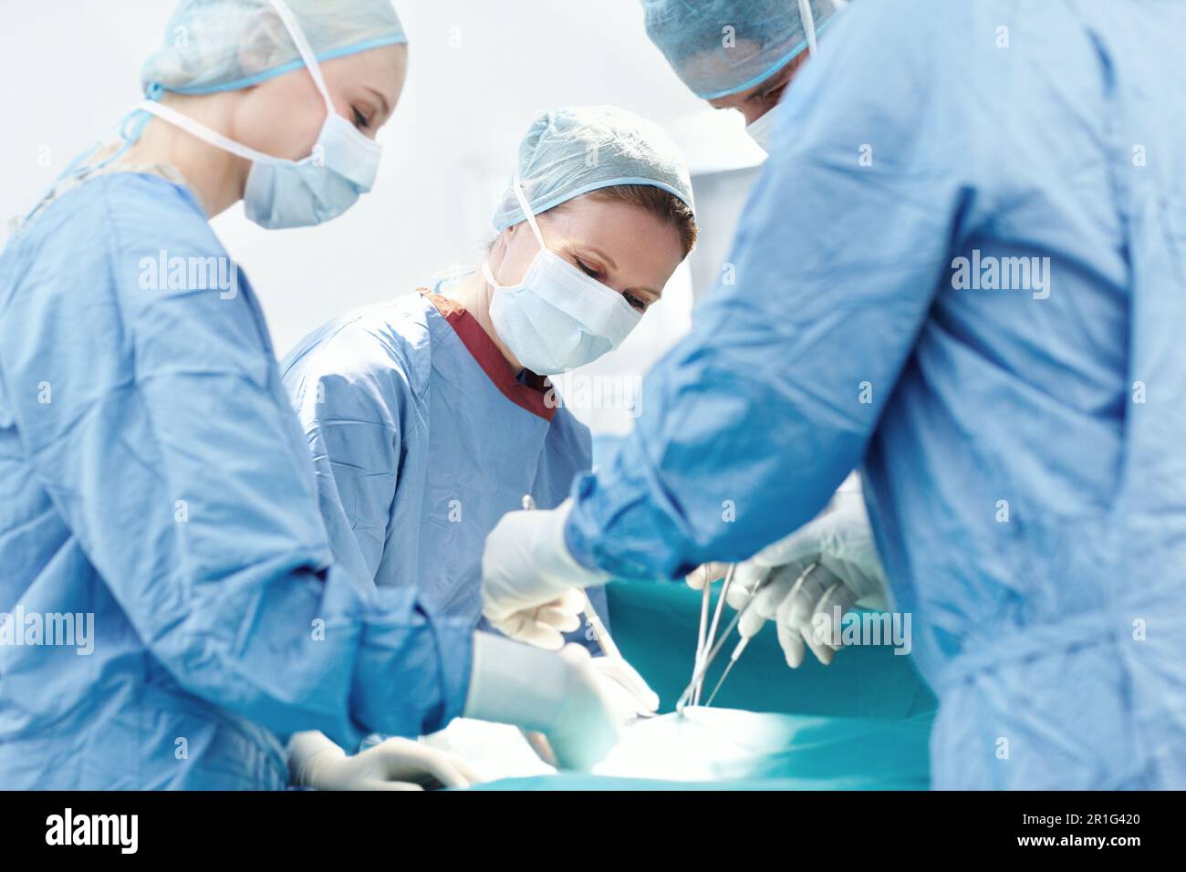 Medical minds at work. Surgeons using medical tools and forceps to ...