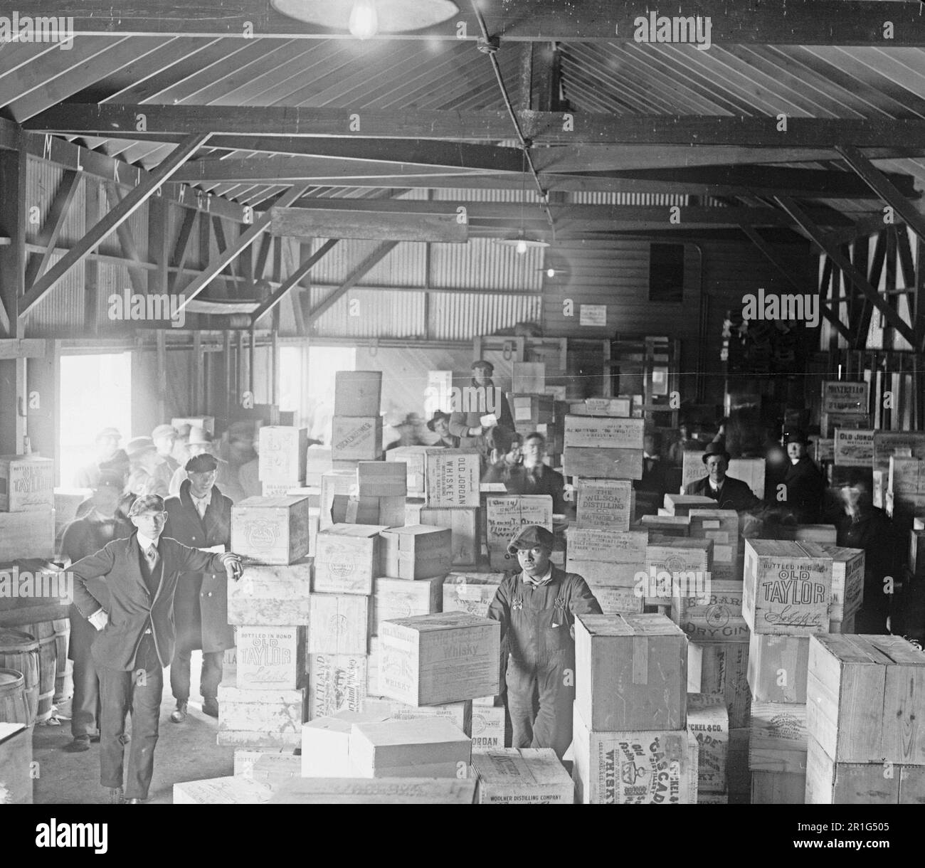 Archival Photo: Officers standing in a warehouse among cases of ...