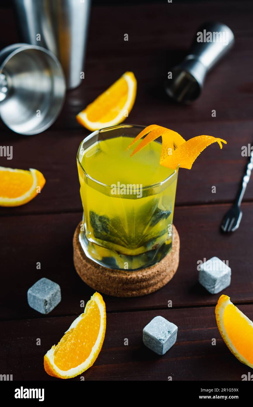 Whiskey cocktail in glass with natural cube stones and orange peel ...
